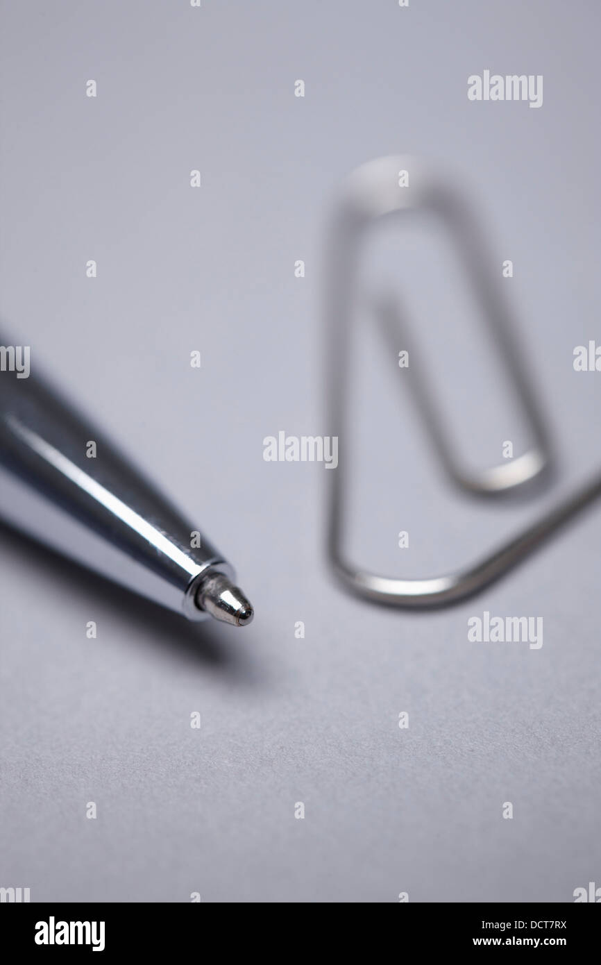 a paper clip and a pen Stock Photo - Alamy