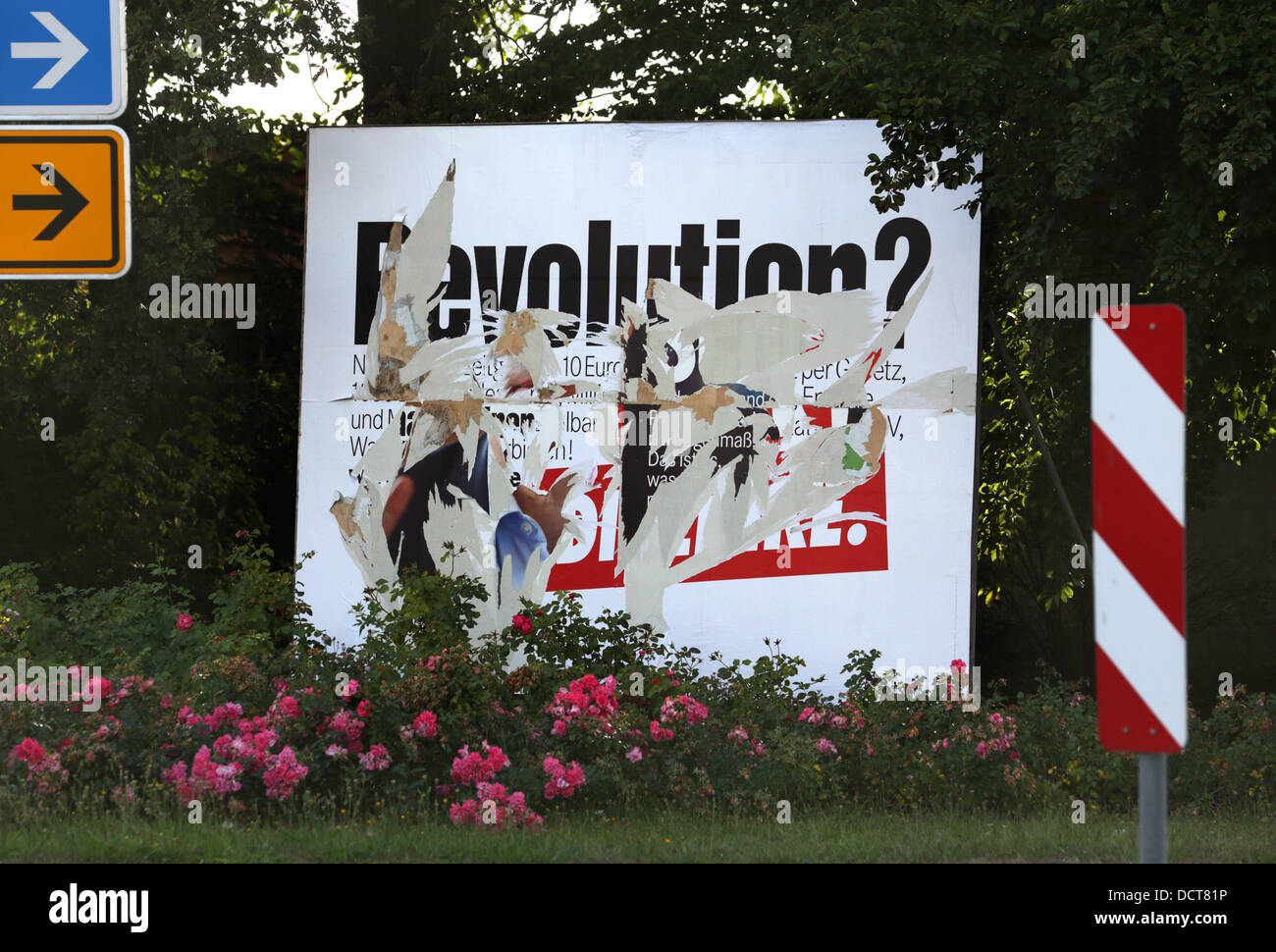 A destroyed election poster of the party The Left stands at the street ...