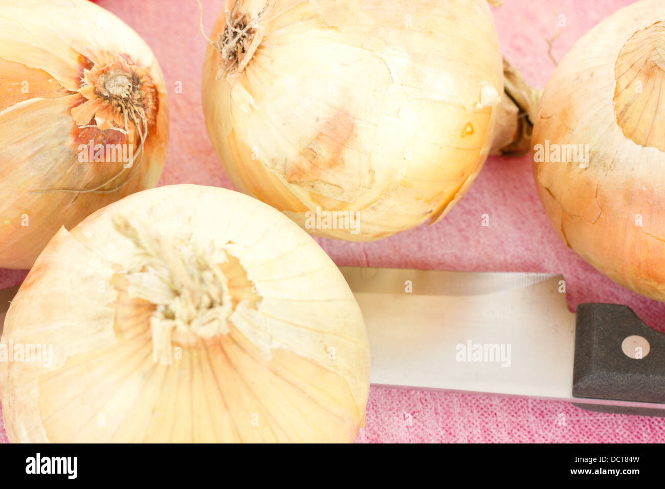 Four onions waiting to be cutted Stock Photo - Alamy