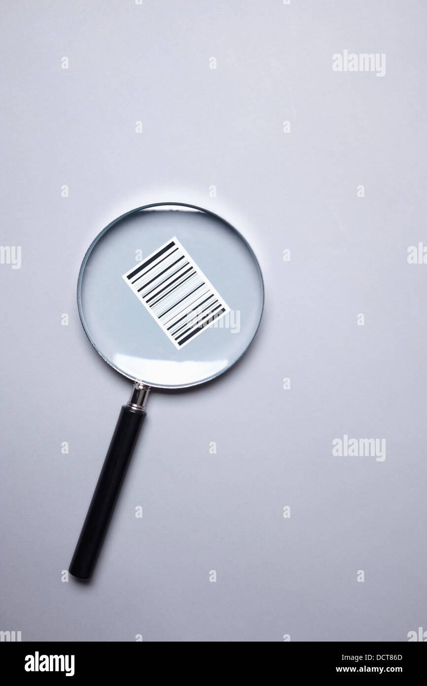 a bar code under a magnifying glass Stock Photo - Alamy