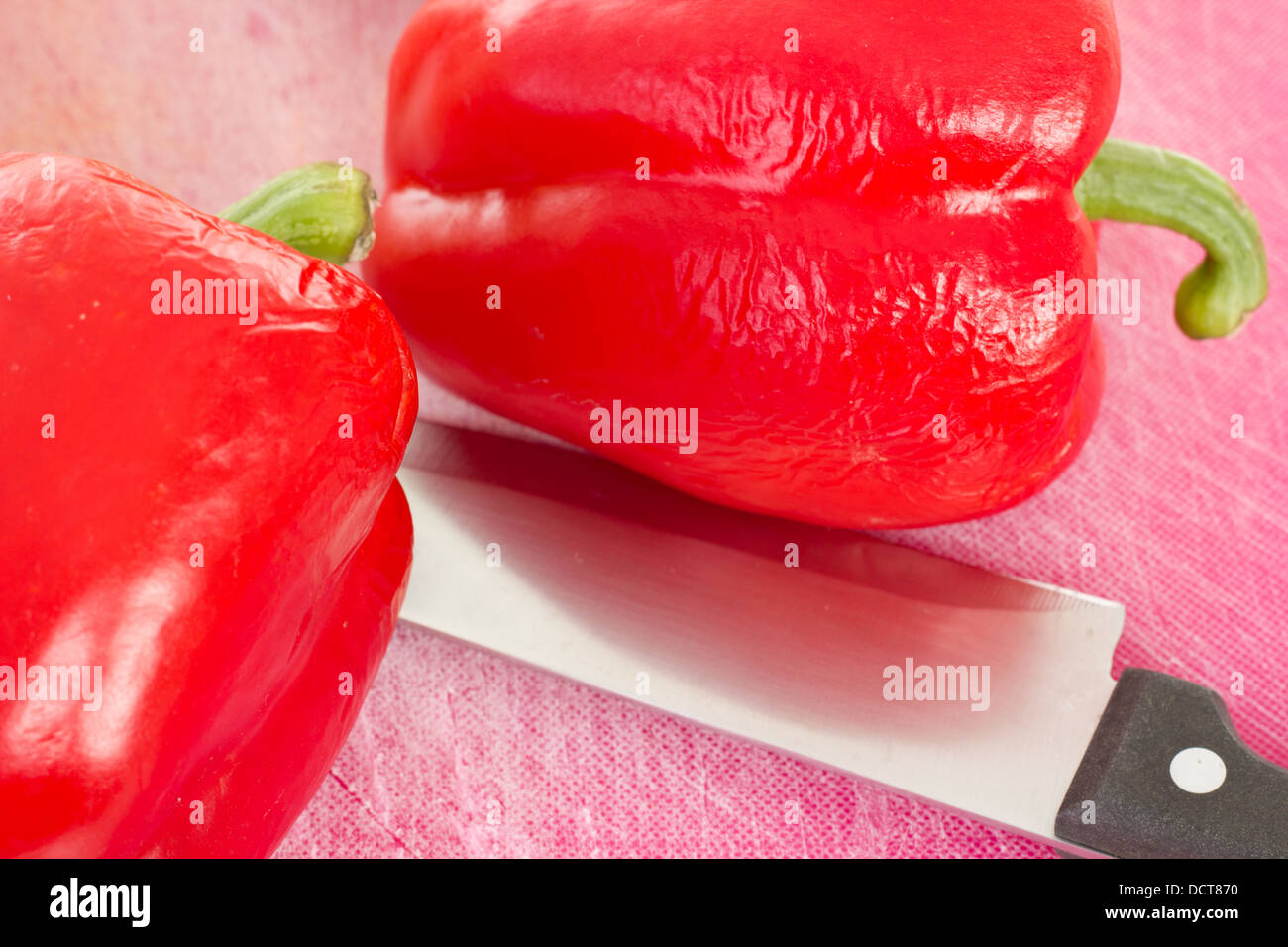 Two red peppers waiting to be cutted Stock Photo - Alamy