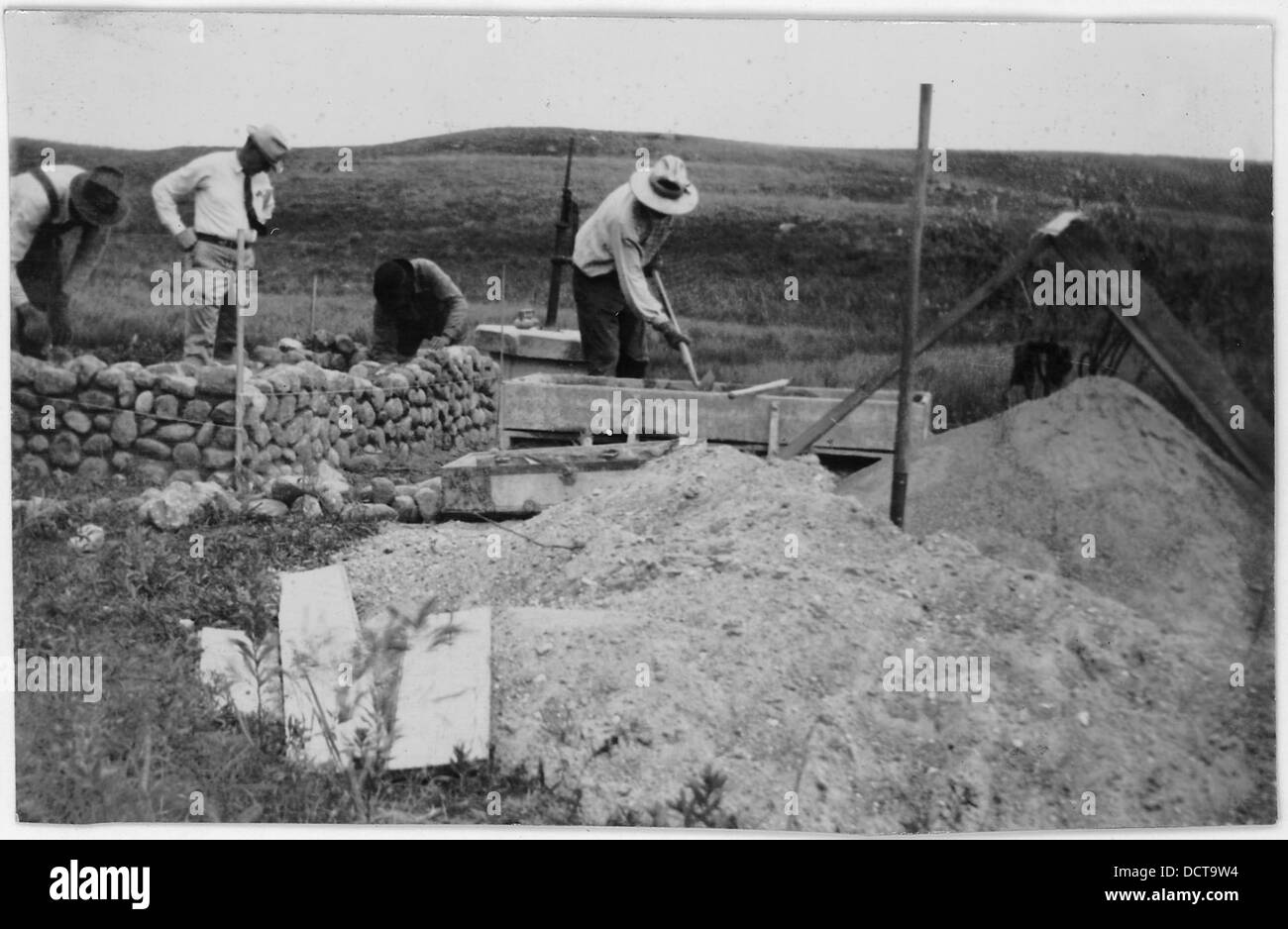 Civilian Conservation Corps (CCC) workers construct a rock wall ...