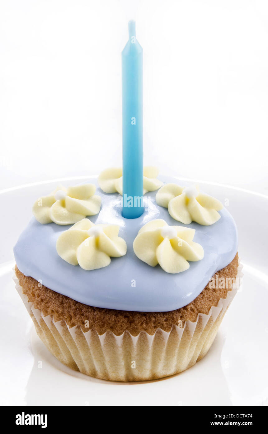 cupcake with blue icing and flower Stock Photo - Alamy
