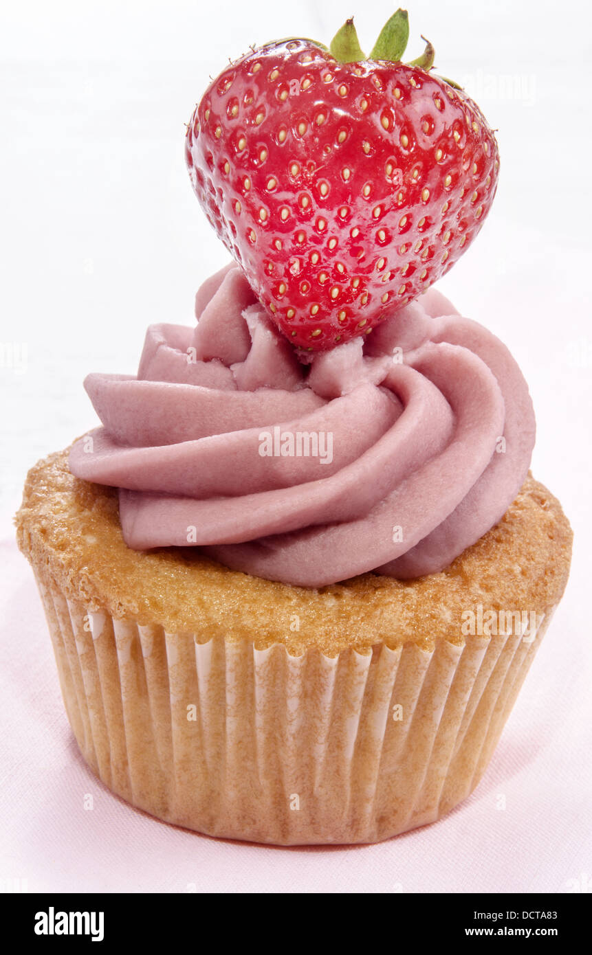 cupcake with one organic strawberry Stock Photo - Alamy