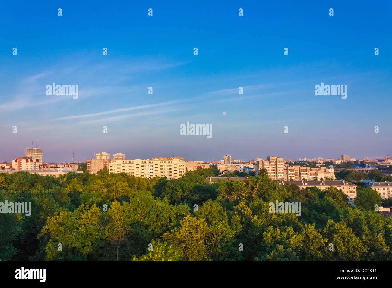 Buildings In A City In An Environment Of Green Trees Stock Photo - Alamy