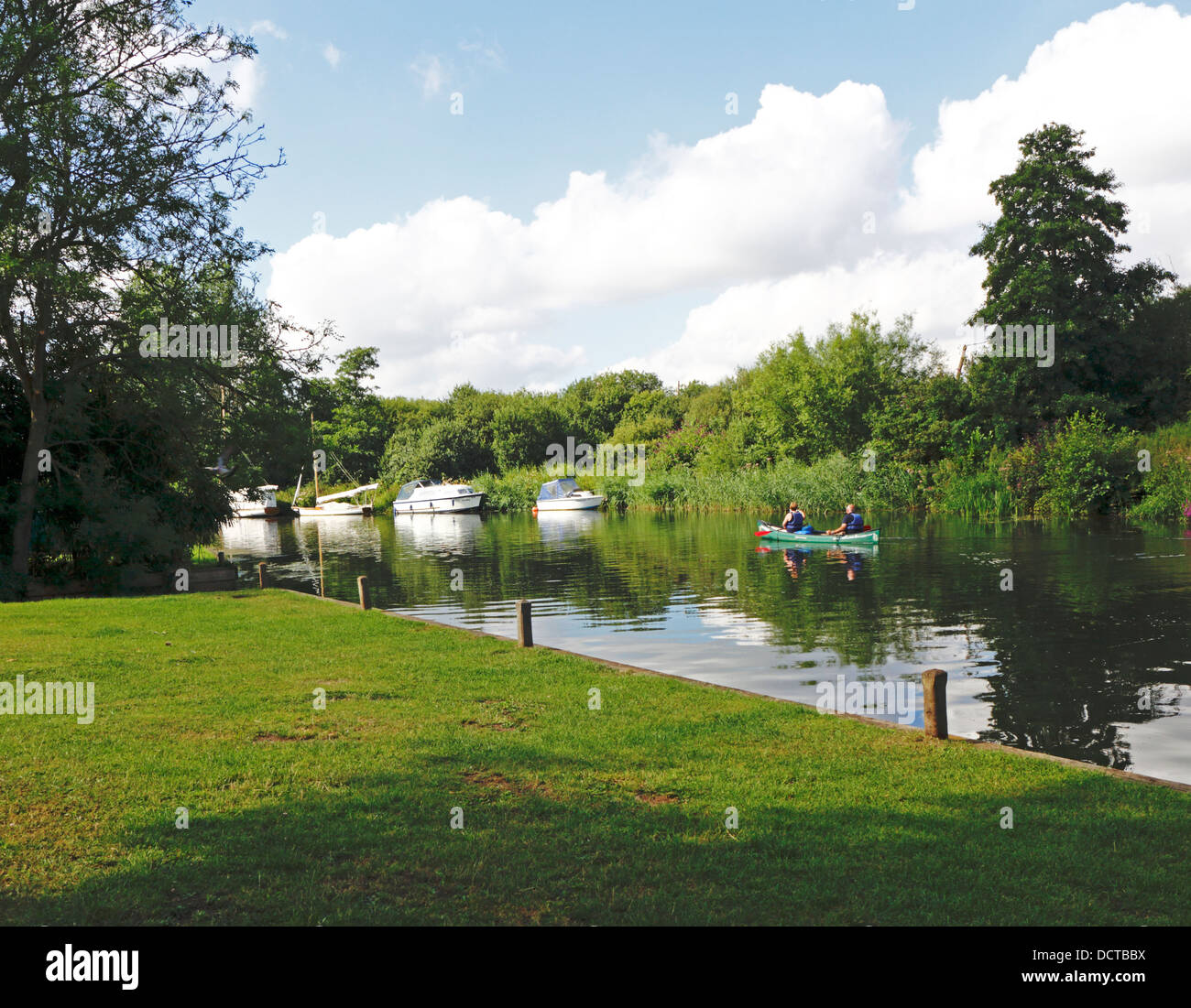 A view of canoeists on the River Bure on the Norfolk Broads at Belaugh ...