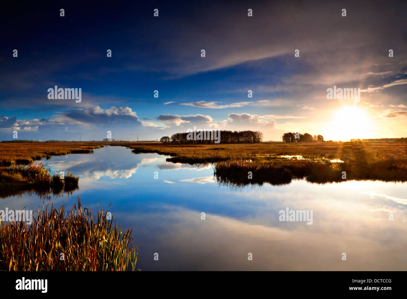 sun at sunrise over lake Stock Photo - Alamy