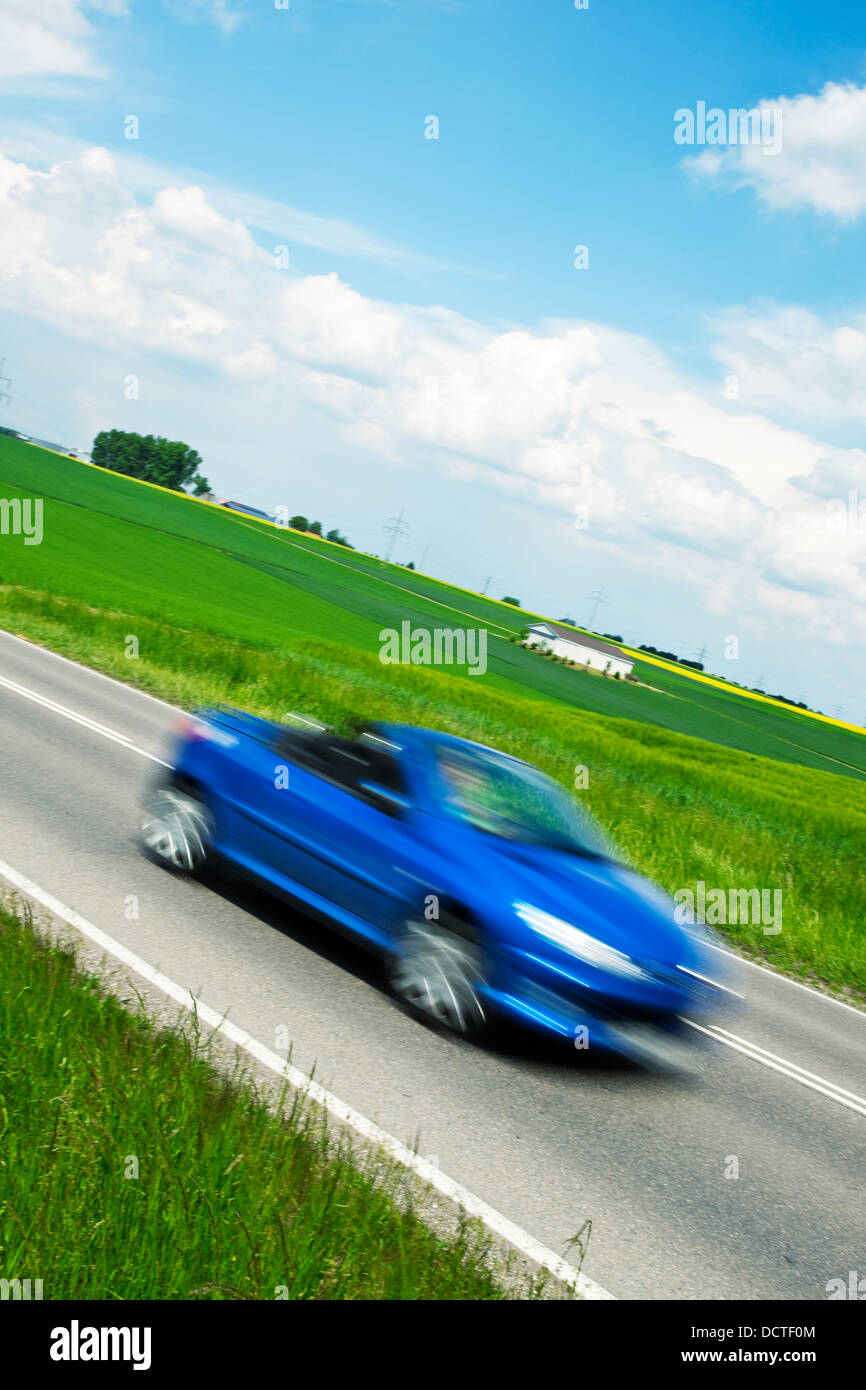 blue car driving on coutry road Stock Photo - Alamy