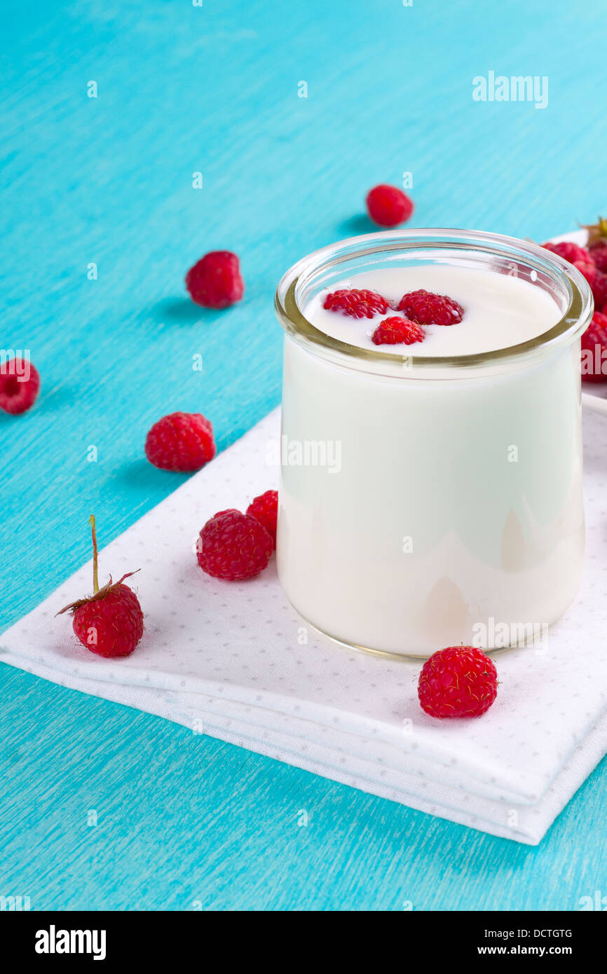 Glass jar full of milk with some fresh raspberries Stock Photo - Alamy