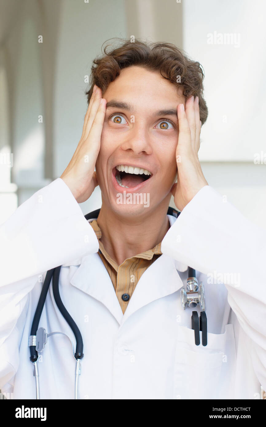 Screaming young doctor Stock Photo - Alamy