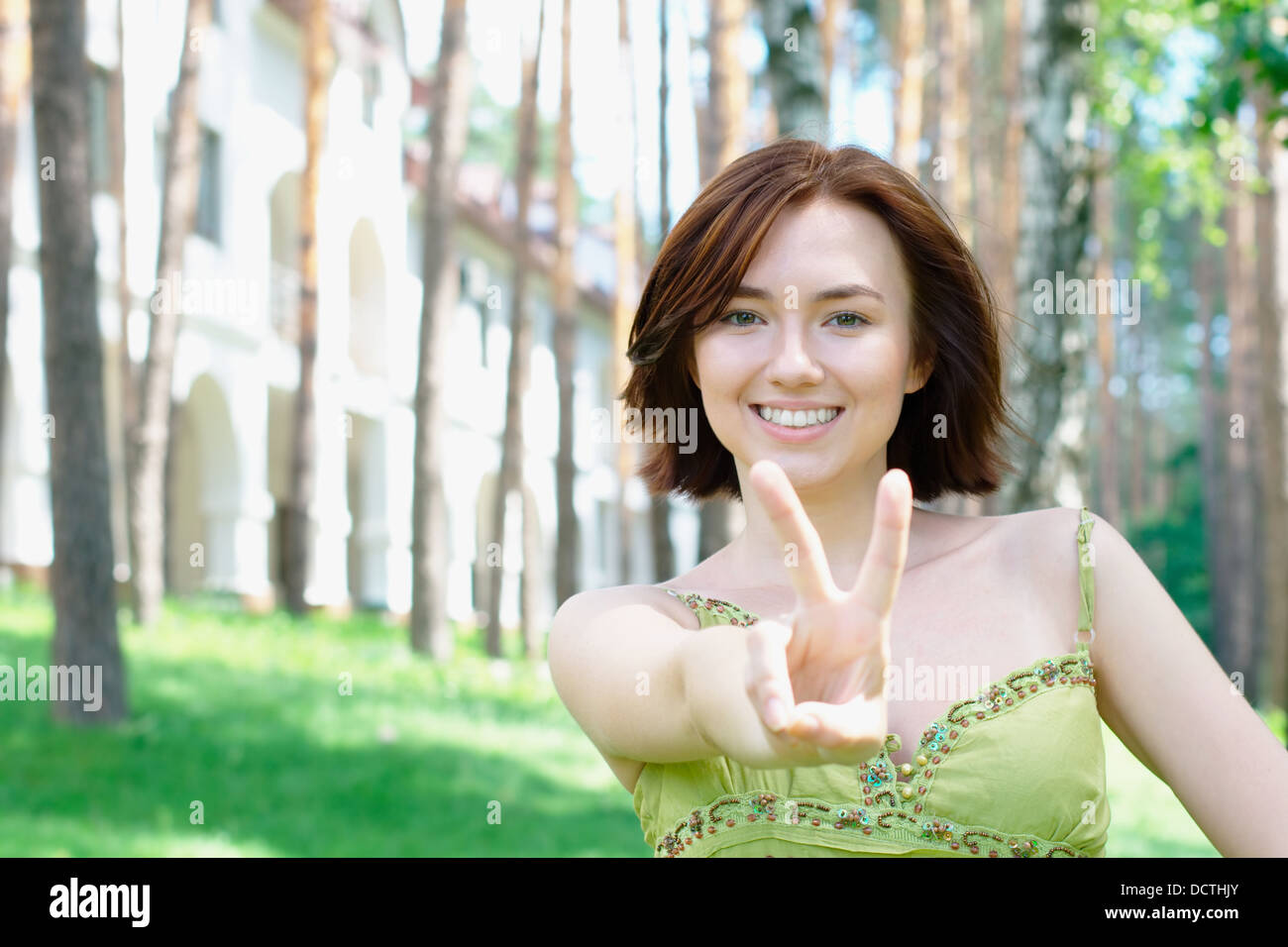 Girl with a victory sign Stock Photo - Alamy