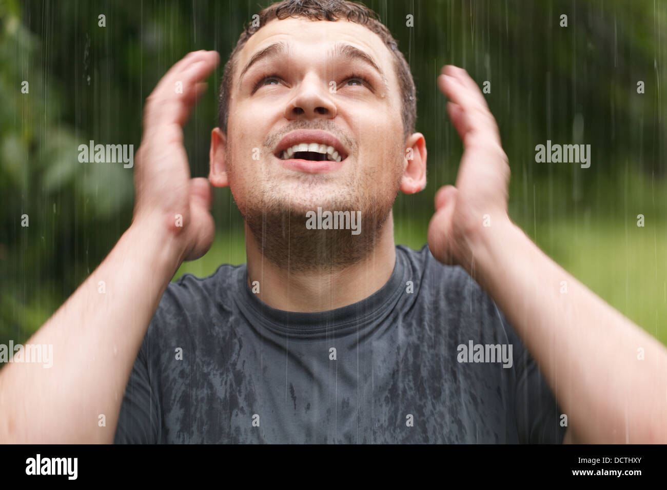 Young man under the rain Stock Photo - Alamy