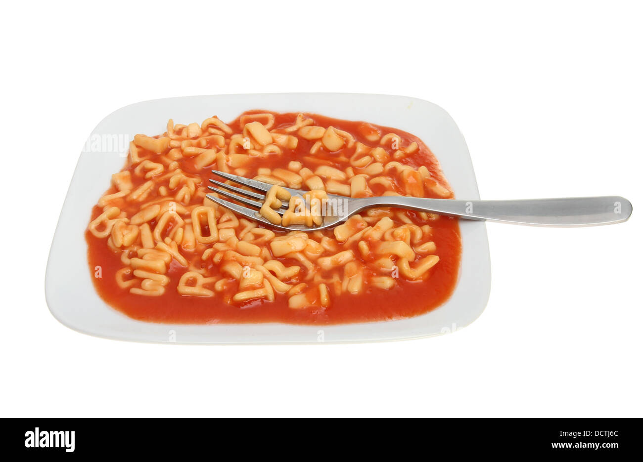 A plate of alphabet spaghetti with a fork with spaghetti spelling eat ...