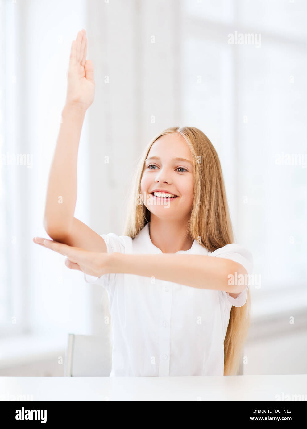 student girl with hand up at school Stock Photo - Alamy