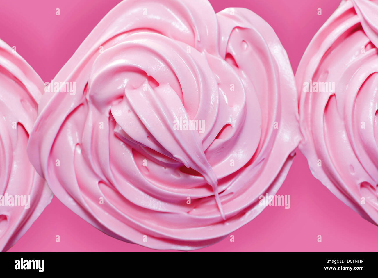 Pink frosting on cupcake Stock Photo - Alamy