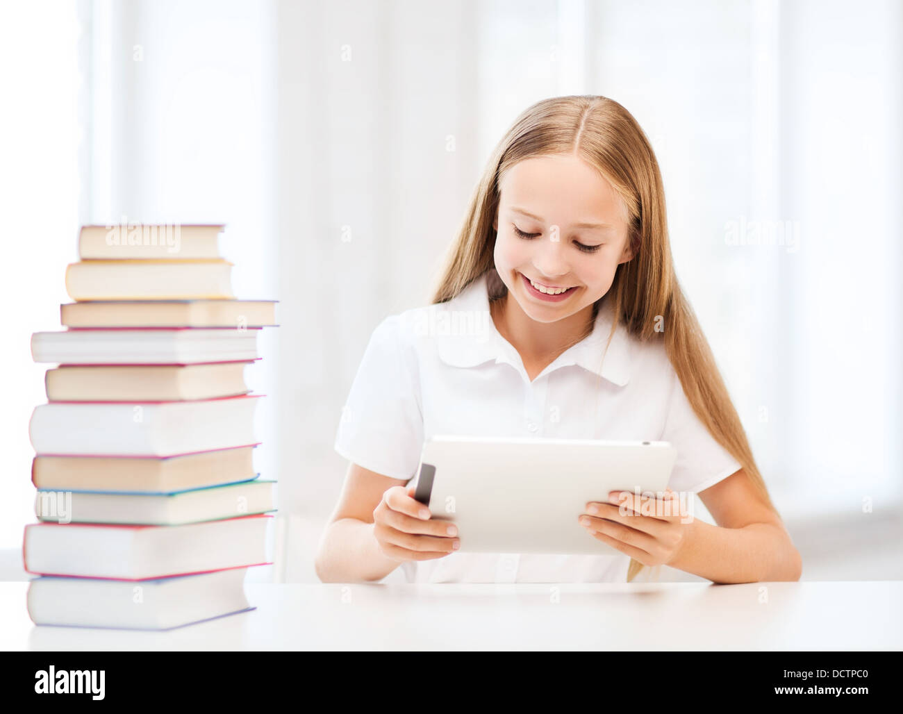 girl with tablet pc and books at school Stock Photo - Alamy