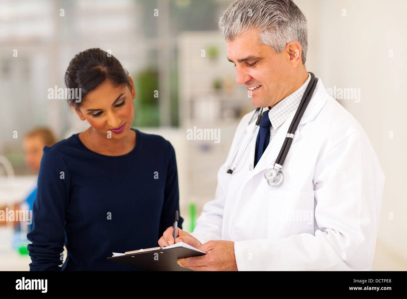 senior doctor checking young patient's test result Stock Photo - Alamy