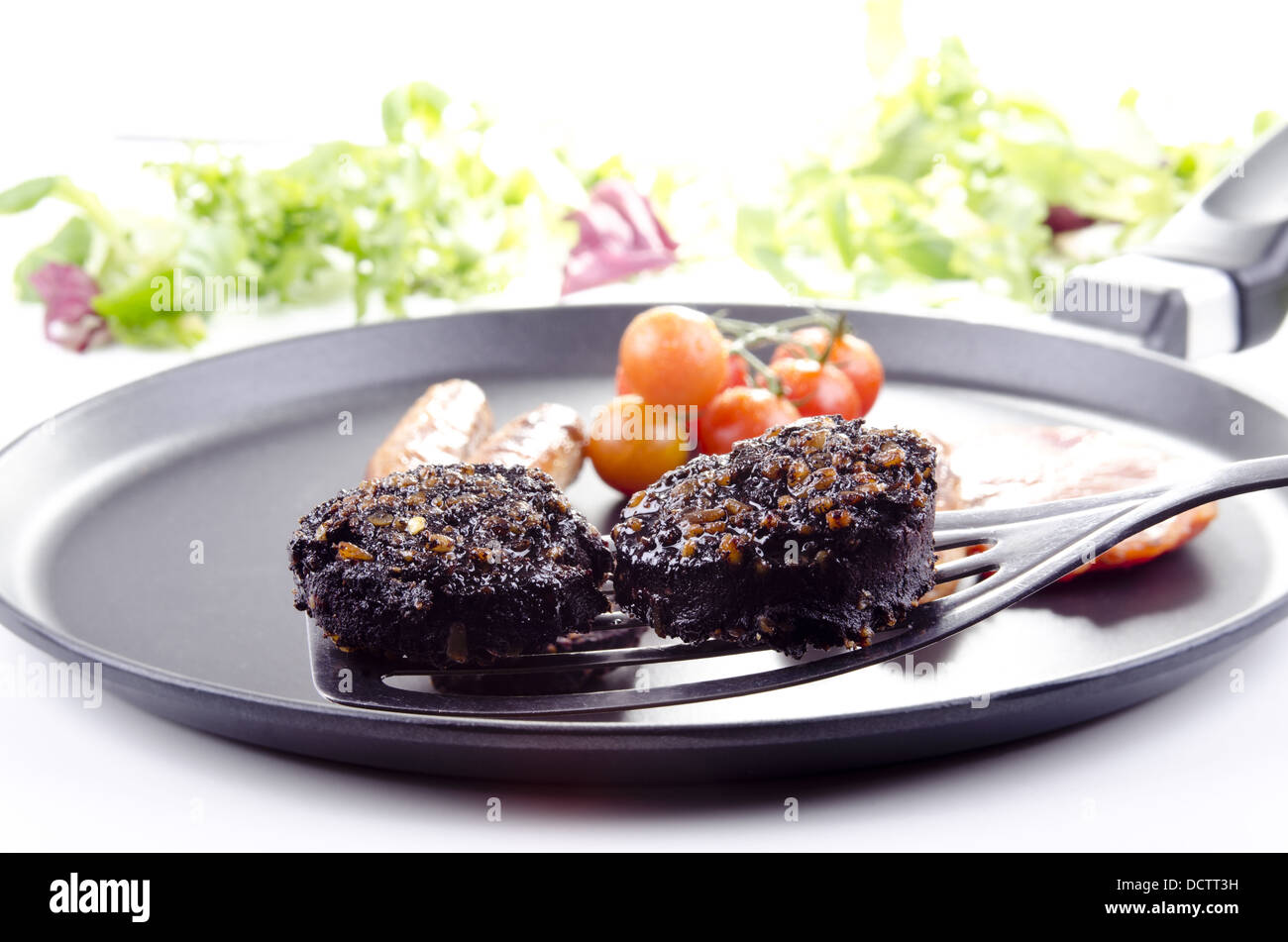 two slices of black pudding on a spatula Stock Photo - Alamy