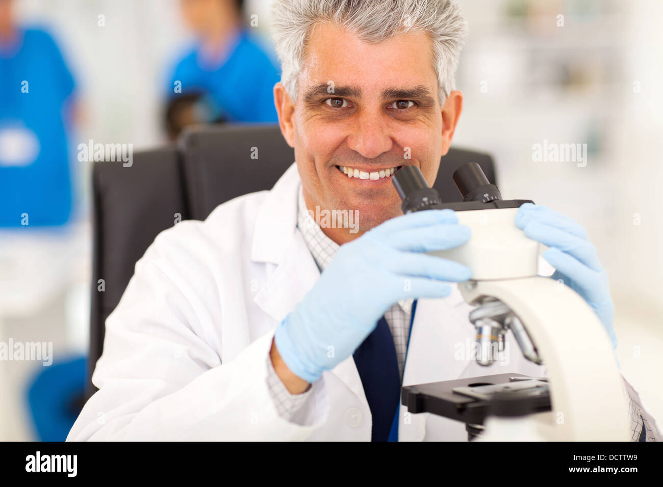 cheerful senior medical researcher using microscope Stock Photo - Alamy