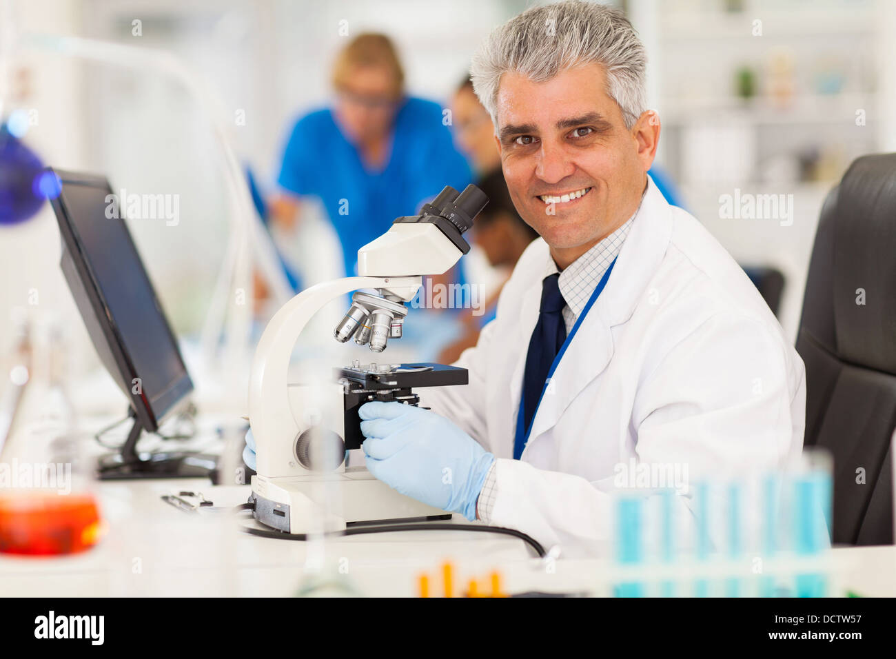 smart middle aged scientist using microscope in the lab Stock Photo - Alamy