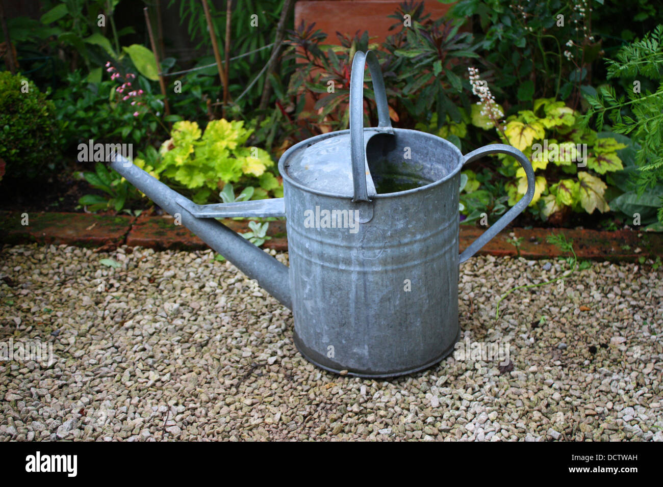 an old silver metal watering can Stock Photo - Alamy