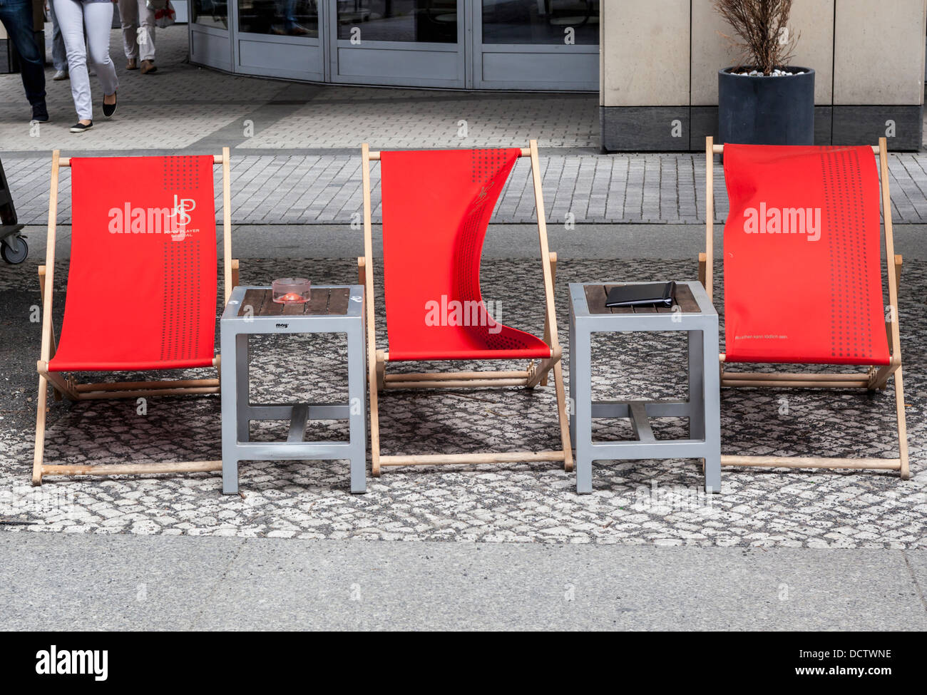 Three red deck chairs Stock Photo - Alamy