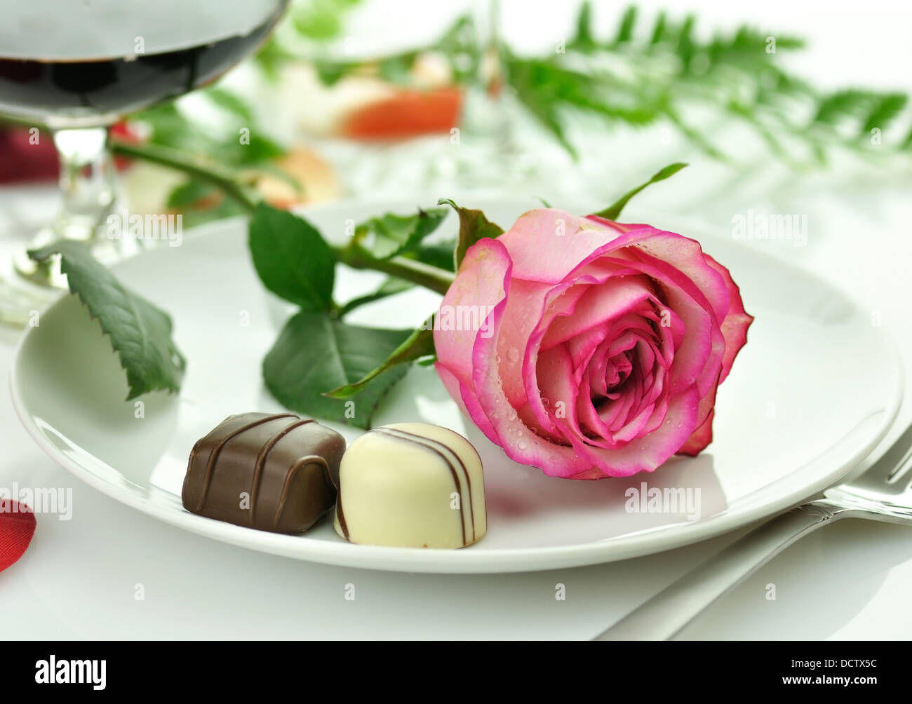 romantic dinner with rose on a plate Stock Photo - Alamy