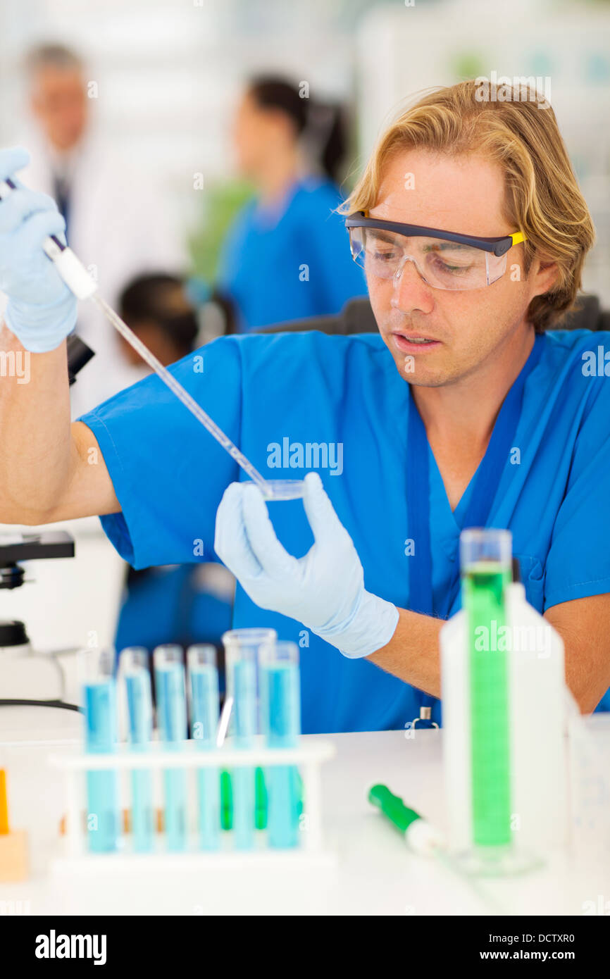 scientist working at the laboratory with co-workers on background Stock ...