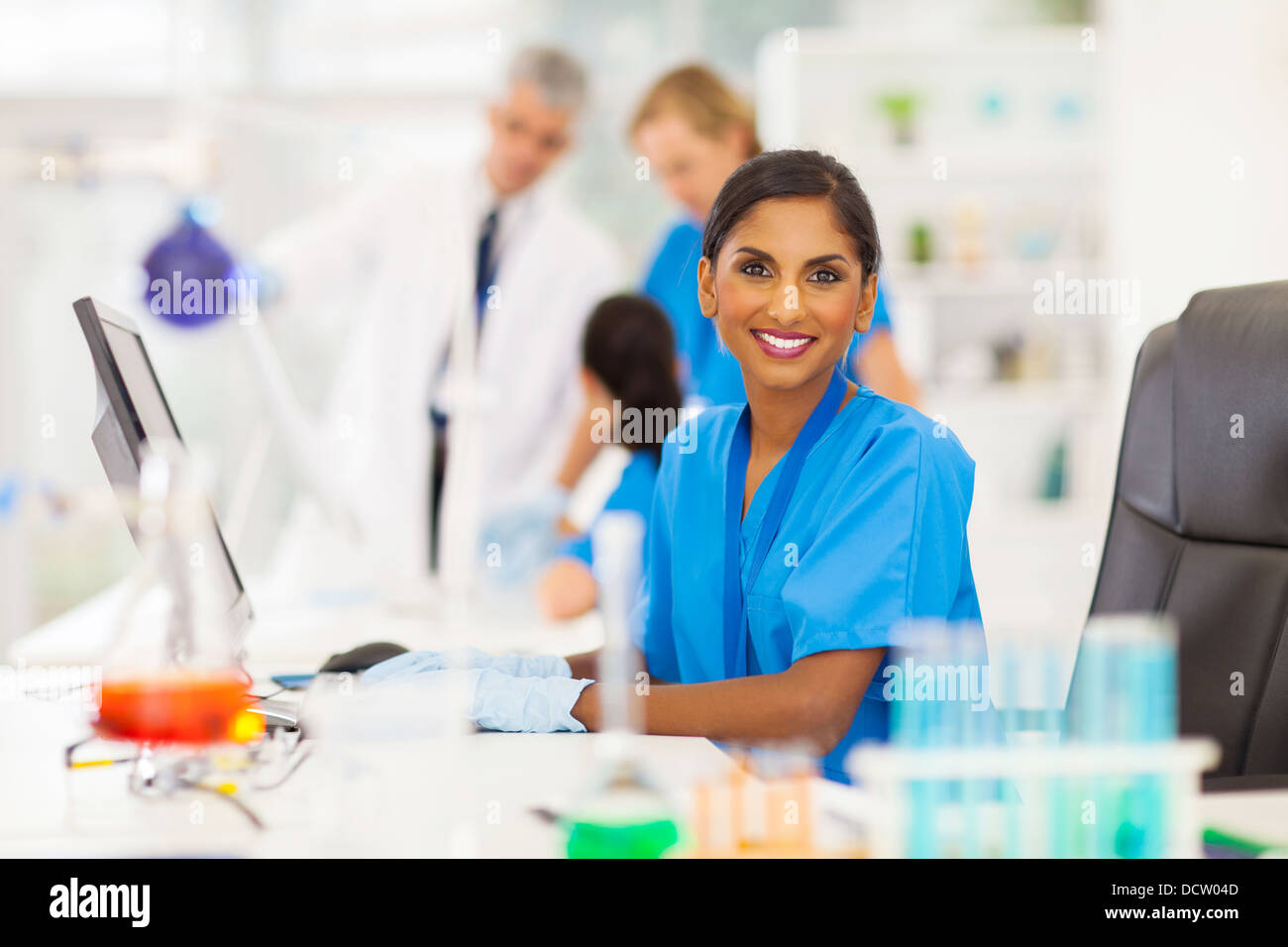 cheerful Indian laboratory worker using computer in lab Stock Photo - Alamy