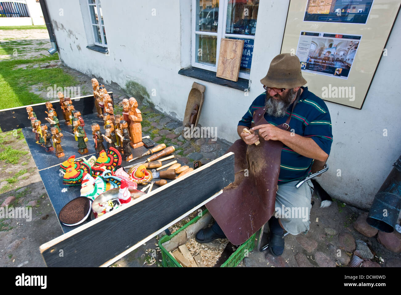 Jewish wood carving artist in front of the ancient synagogue in Tykocin ...