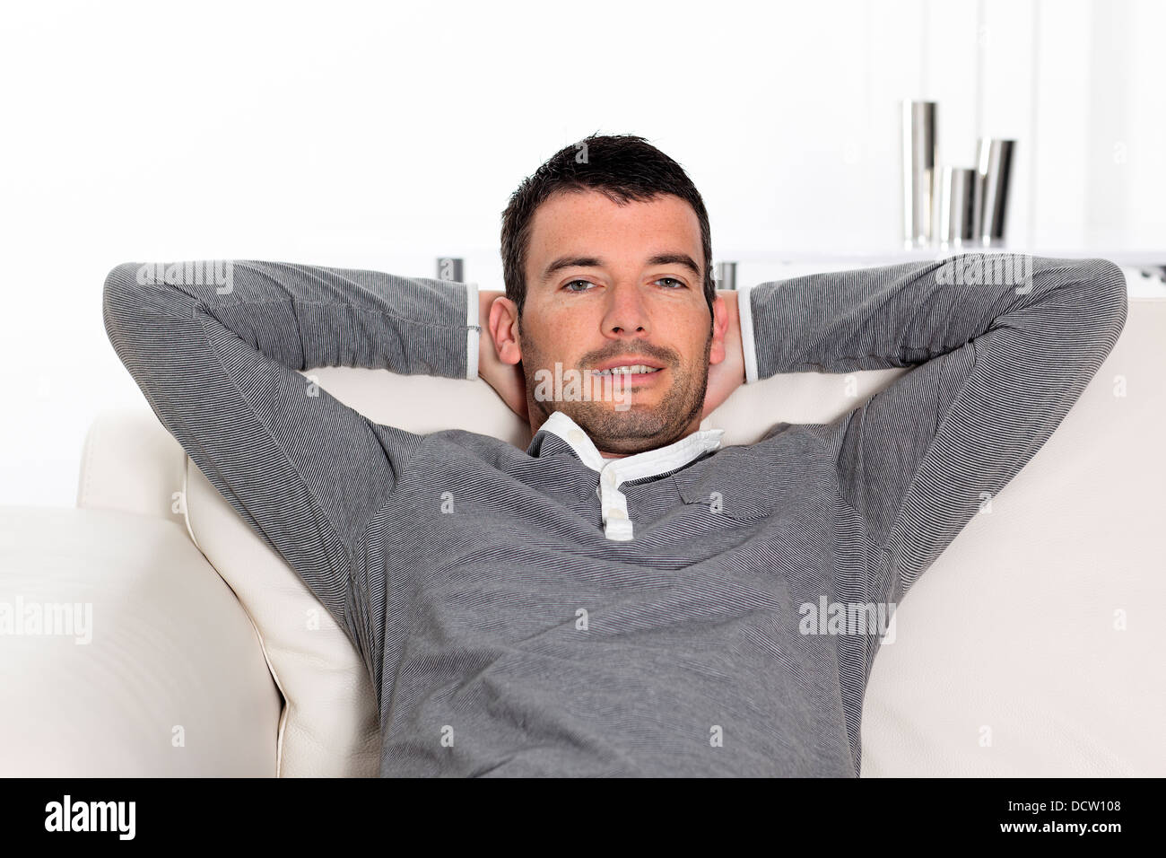 relaxed man on sofa Stock Photo - Alamy