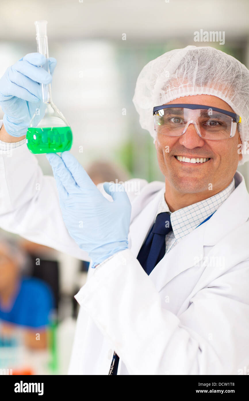 Smiling chemist holding test hi-res stock photography and images - Alamy