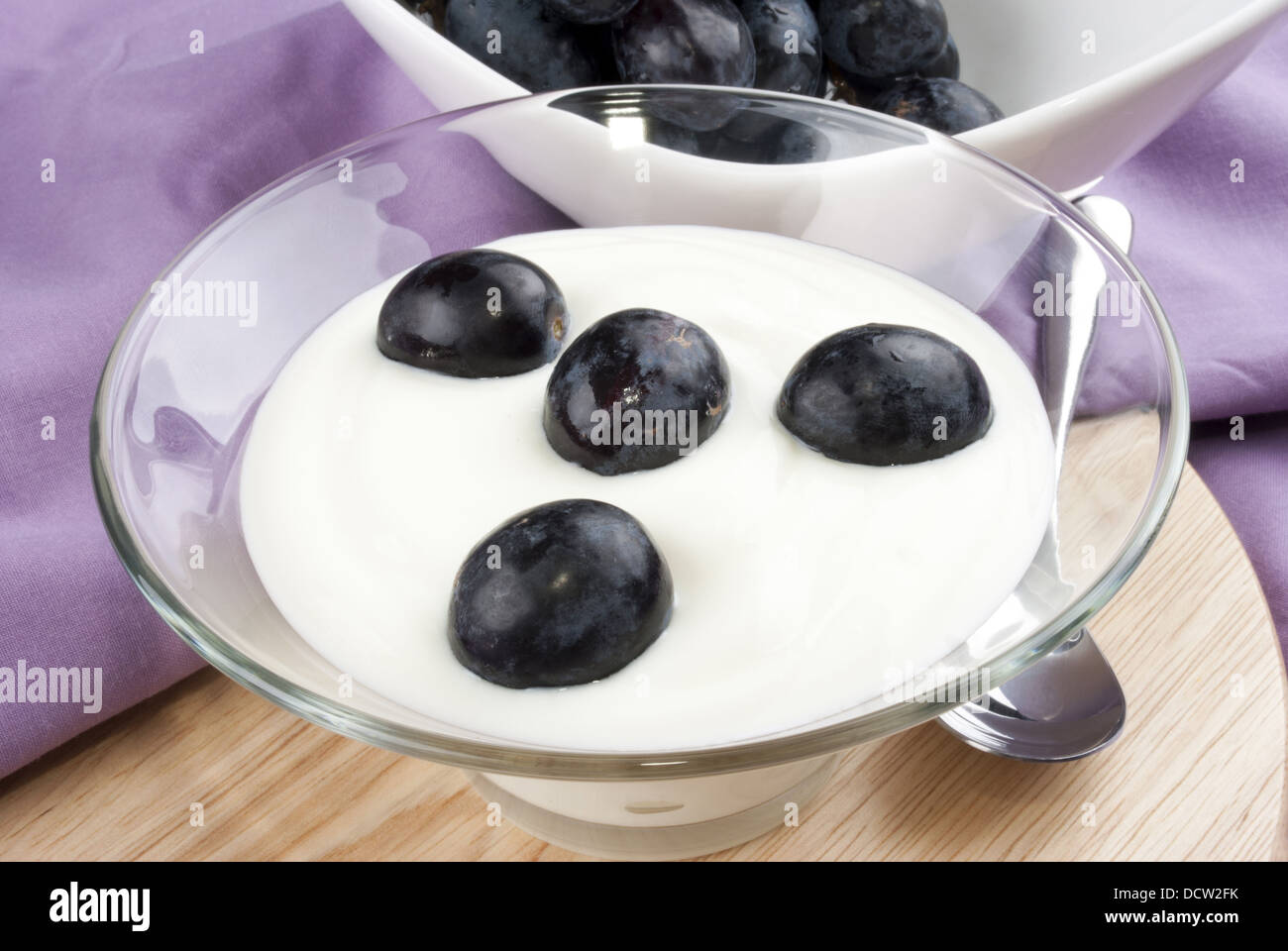 blue grapes with fresh yogurt and a spoon Stock Photo - Alamy
