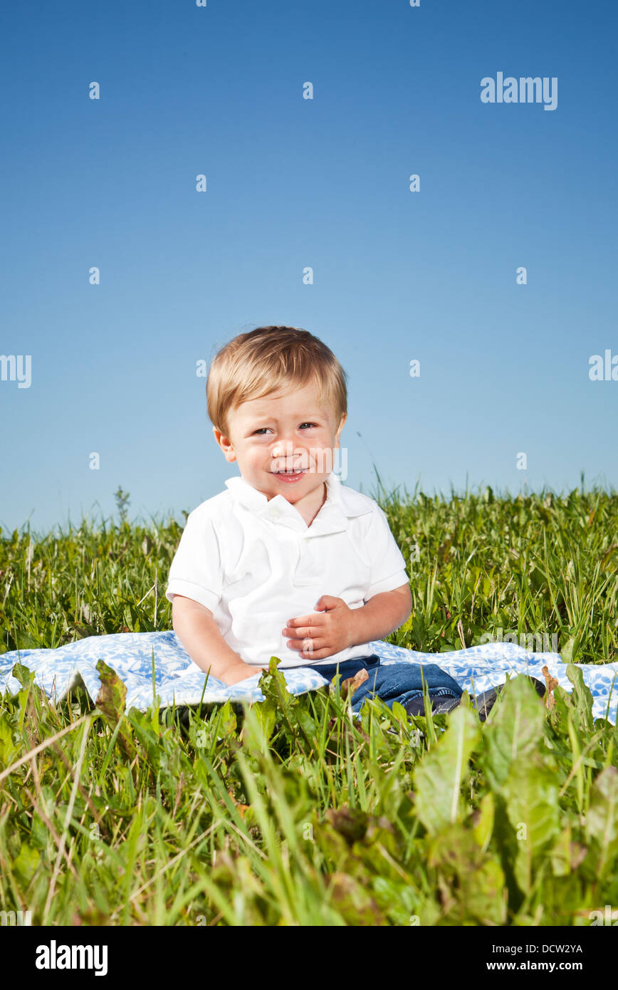 Child in the grass Stock Photo - Alamy