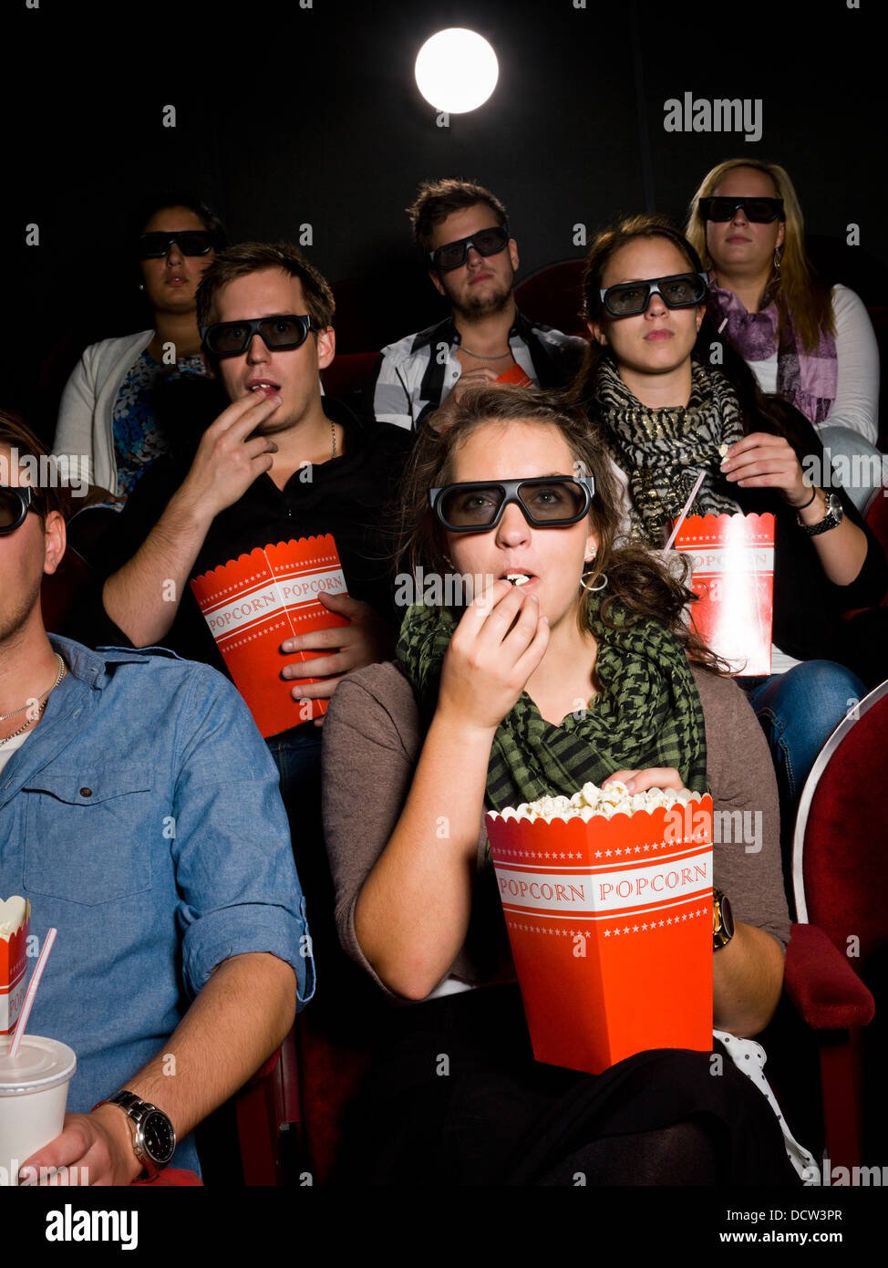 Eating popcorn at the cinema Stock Photo - Alamy