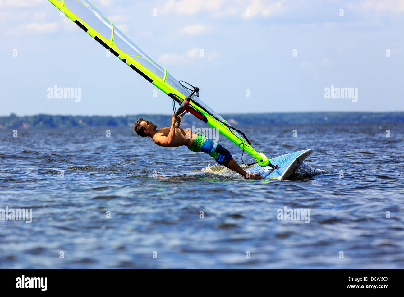 Side view of a windsurfer falls to water Stock Photo - Alamy