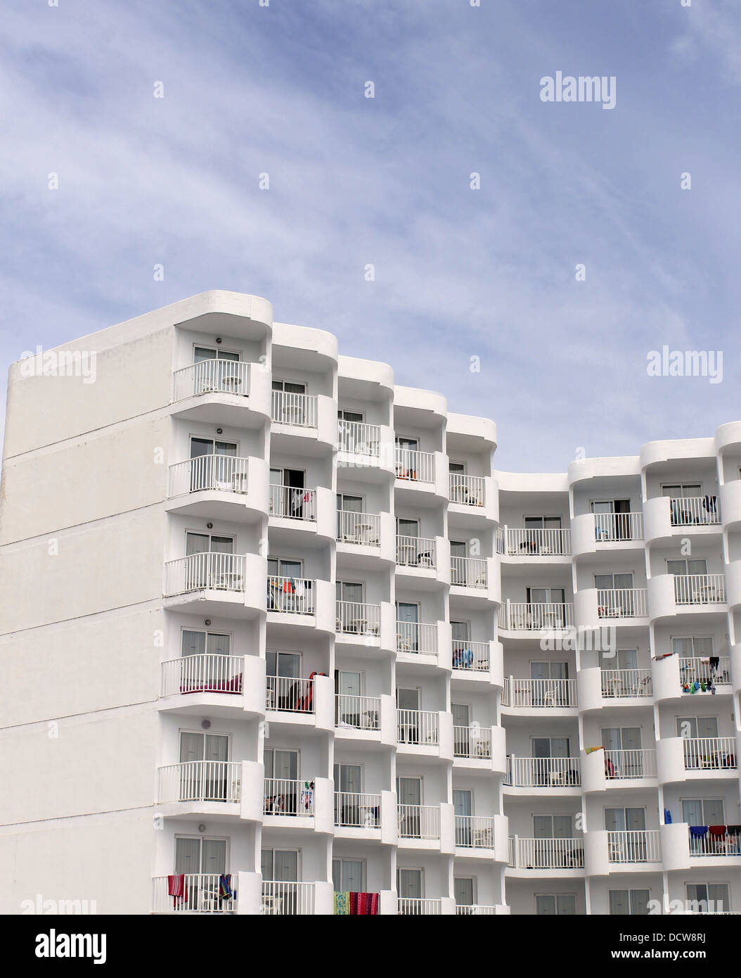 Tall white tourist hotel with cloudscape background Stock Photo - Alamy