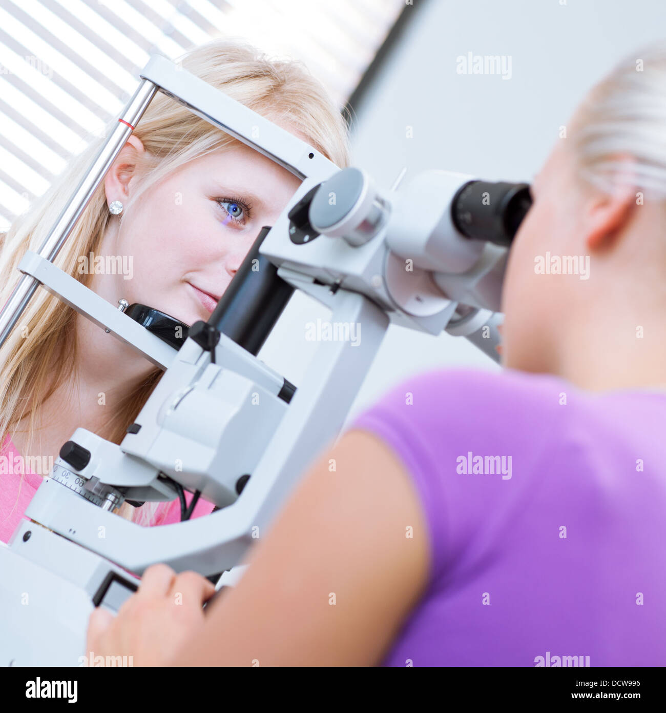 optometry concept - pretty, young female patient having her eyes Stock ...