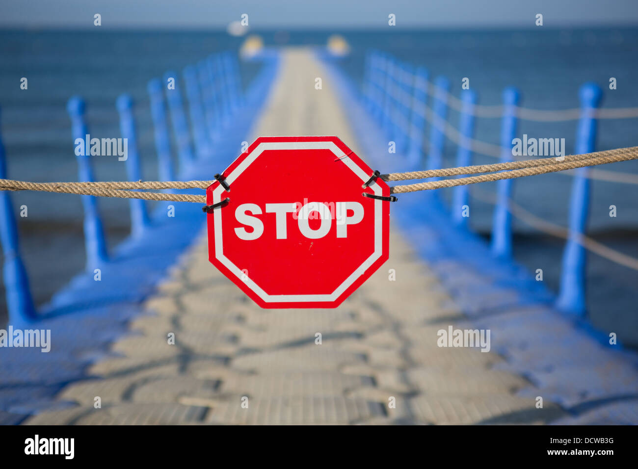 A stop sign bars entry to a pier leading out to the sea Stock Photo - Alamy