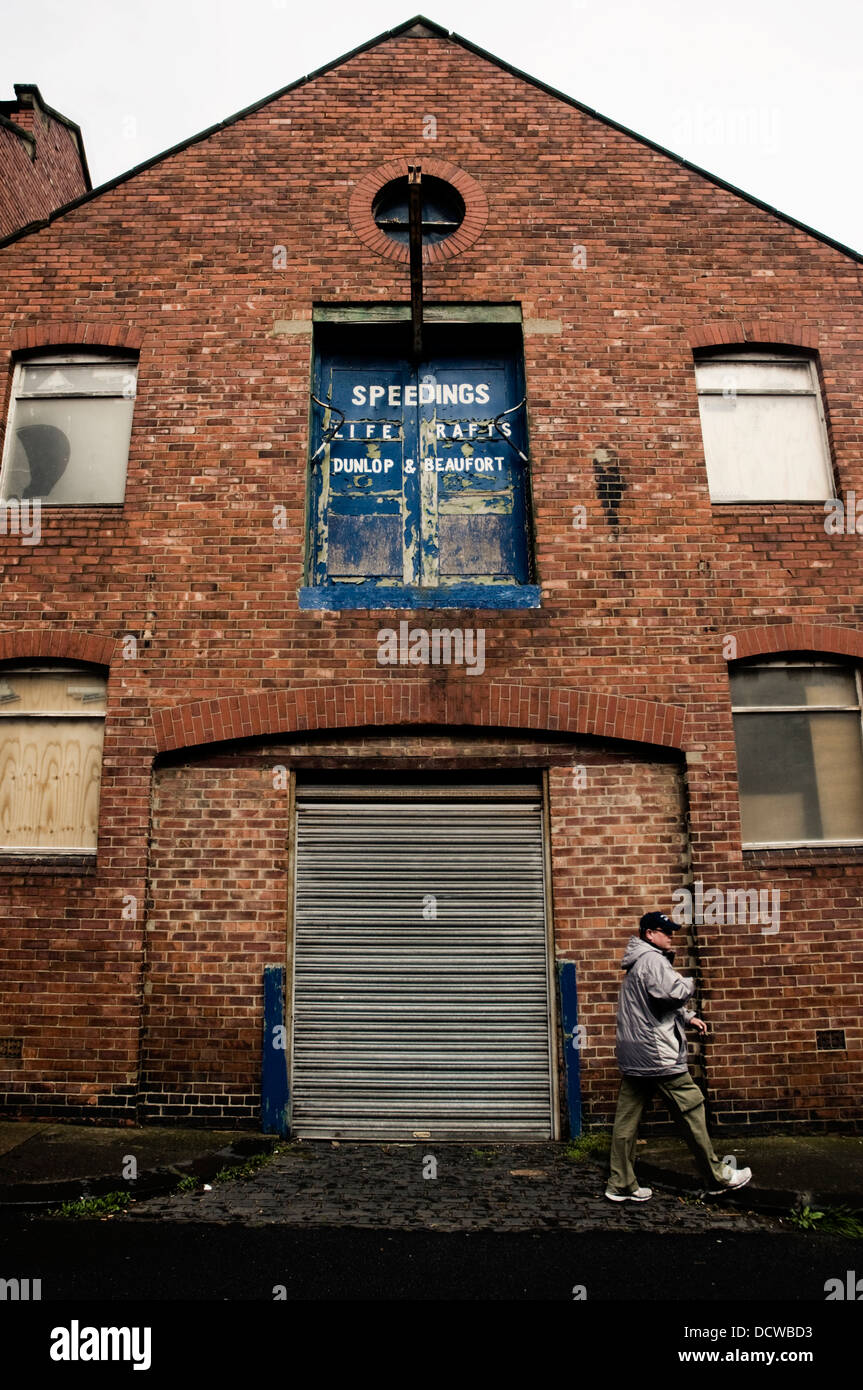 A man walks past an empty factory in Sunderland, north east England ...