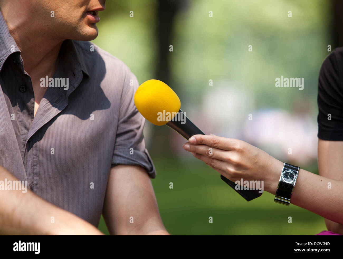 A journalist is making a interview with a microphone Stock Photo - Alamy