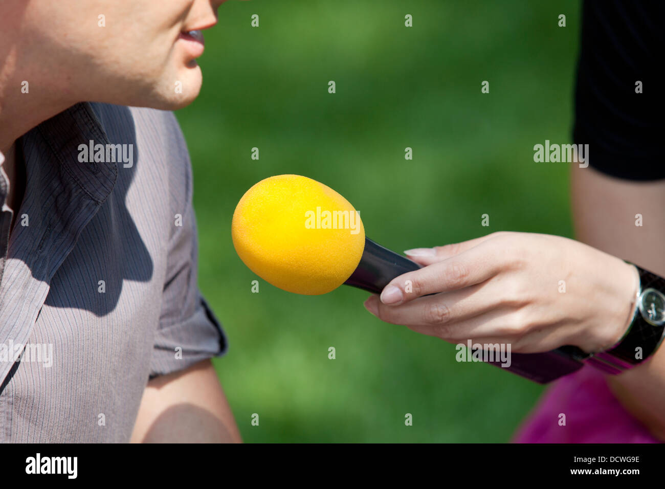 A journalist is making a interview with a microphone Stock Photo - Alamy