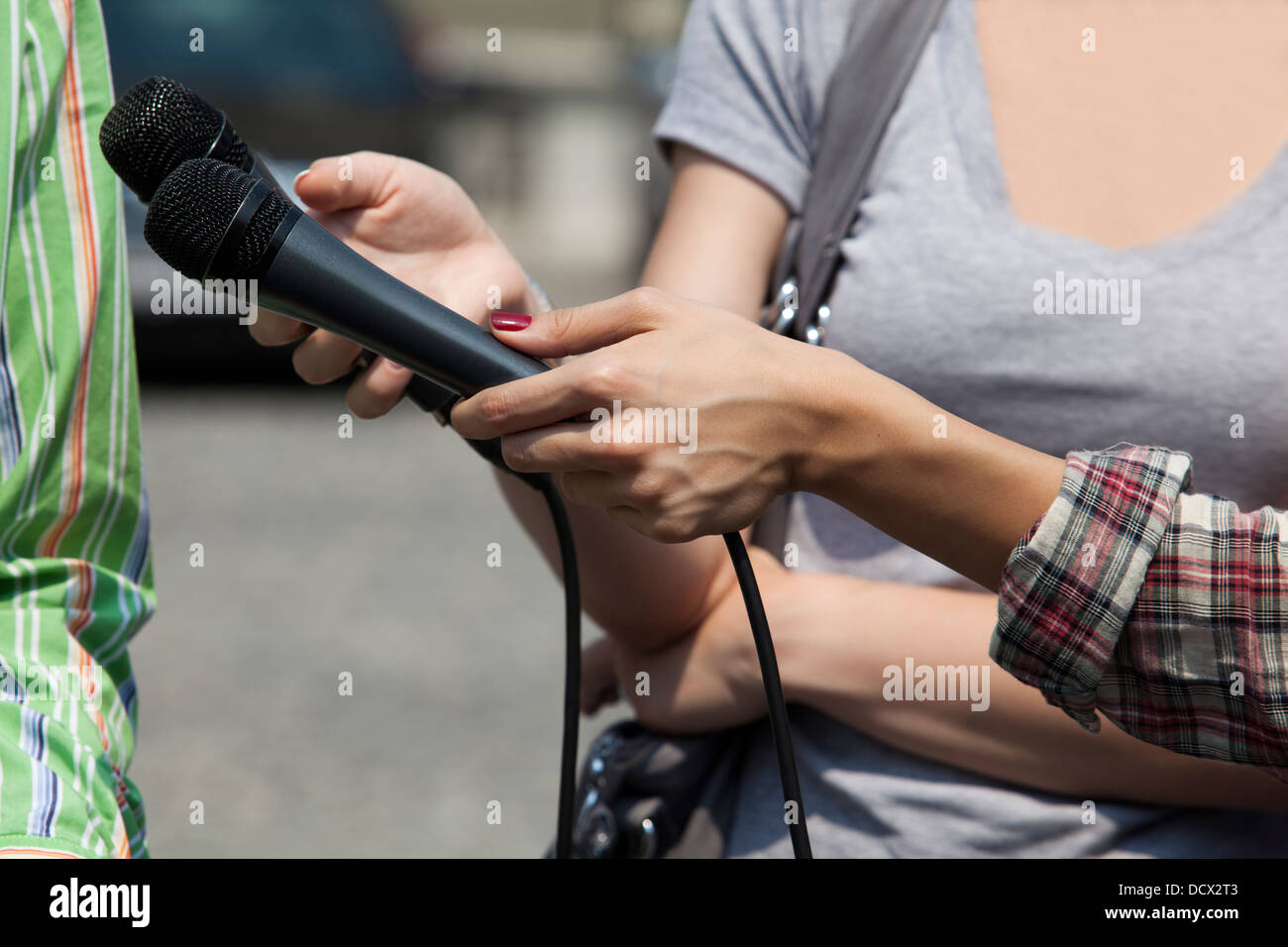 A journalist is making a interview with a microphone Stock Photo - Alamy