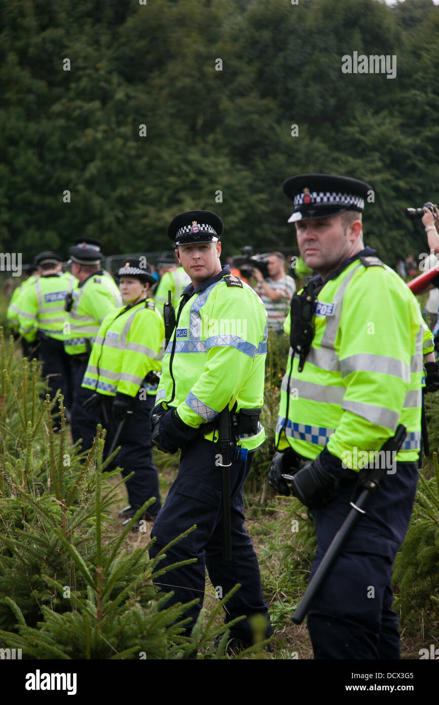 Police lines in a field of baby Christmas trees to protect the ...