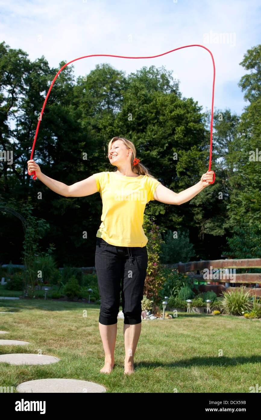 Young active woman has fun with jumping rope Stock Photo - Alamy