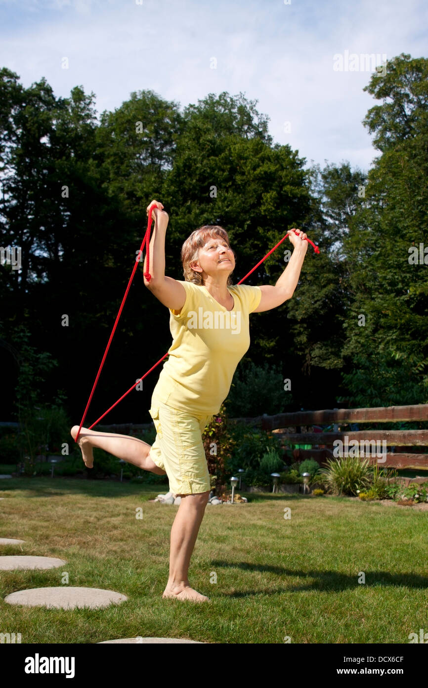 Elderly woman doing exercises with the jump rope Stock Photo - Alamy