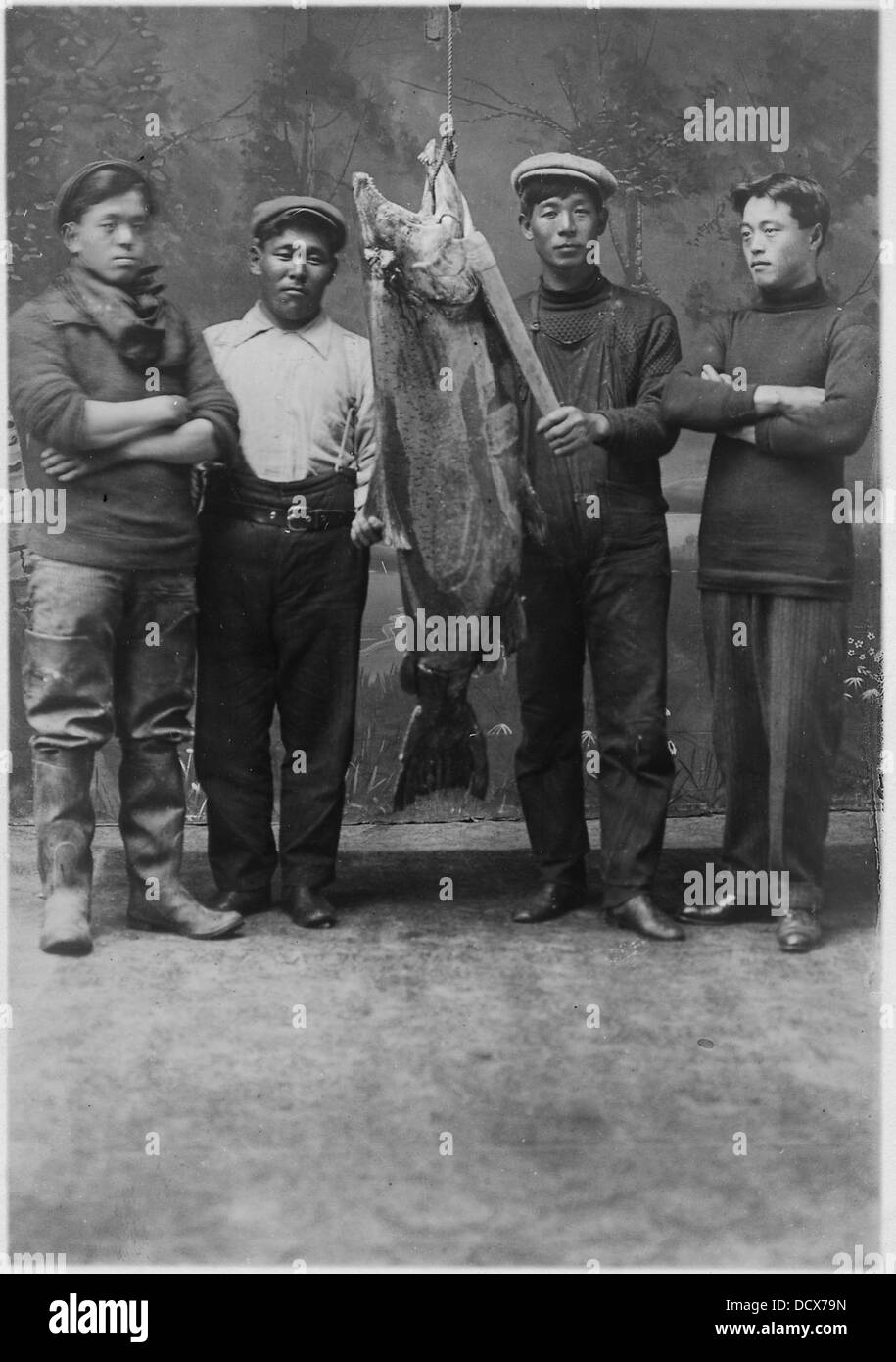 Four young Indigenous men stand with large salmon, a testament to their ...