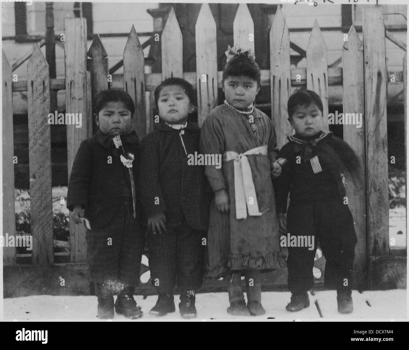 A photograph showing four young Native American children, capturing a ...