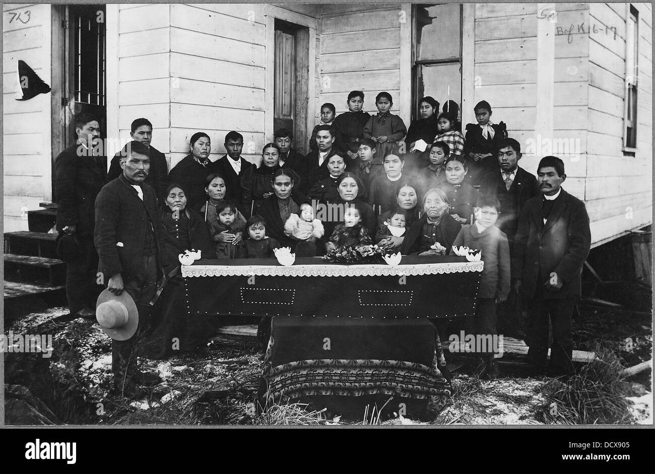 This somber photograph depicts a funeral scene, capturing the solemnity ...