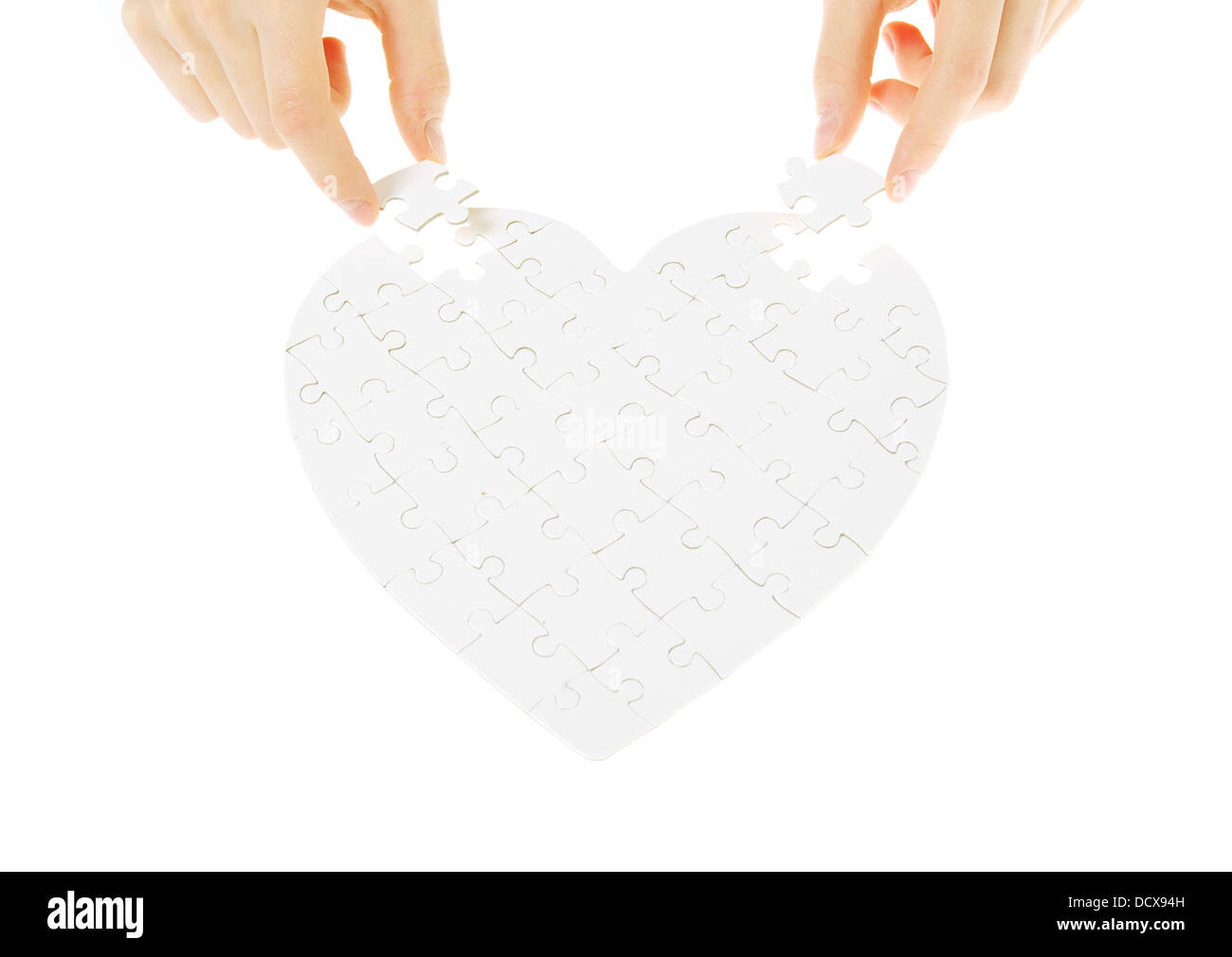 Heart puzzle hands hi-res stock photography and images - Alamy